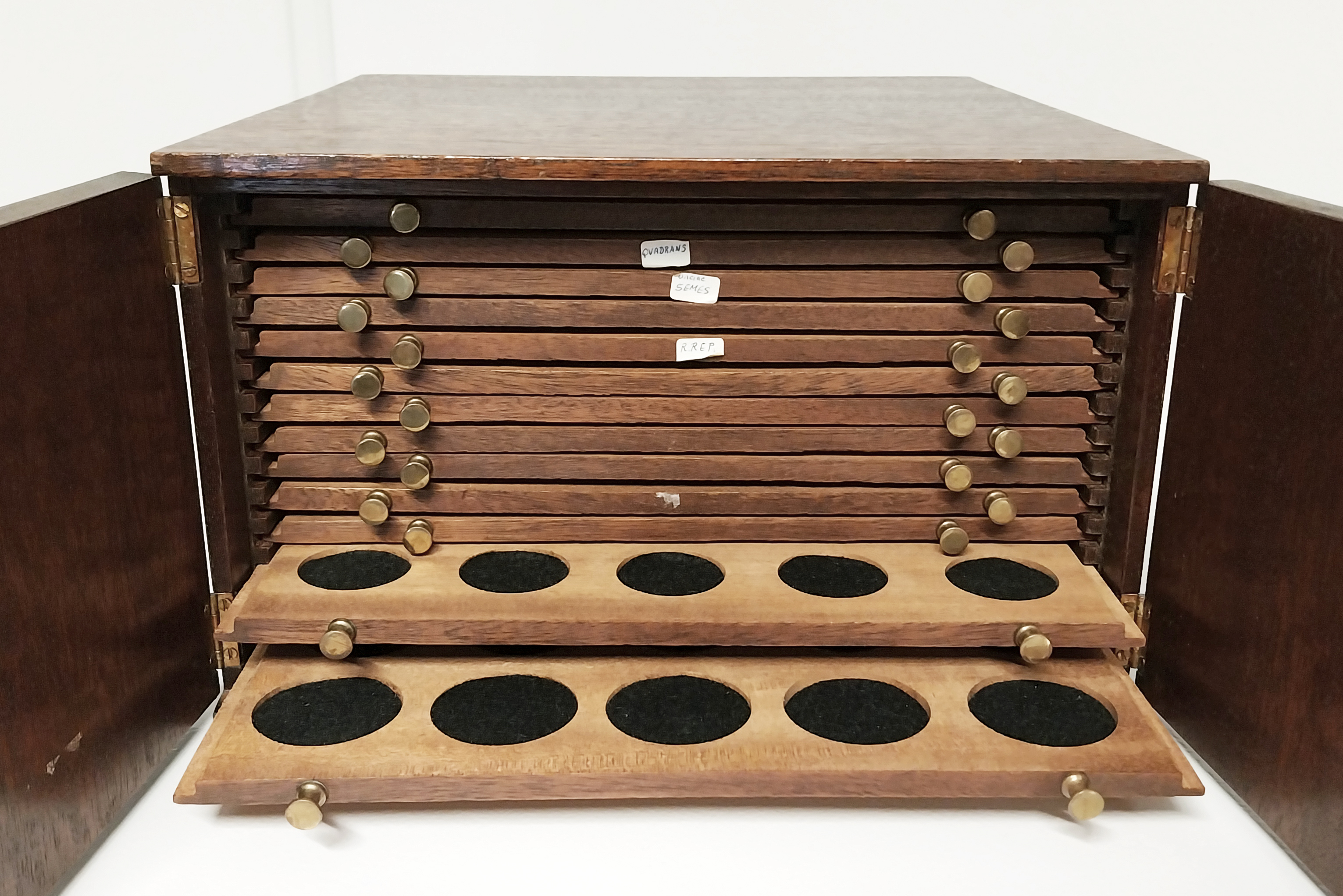 A dark mahogany coin cabinet with plain double doors. . Exterior a ...