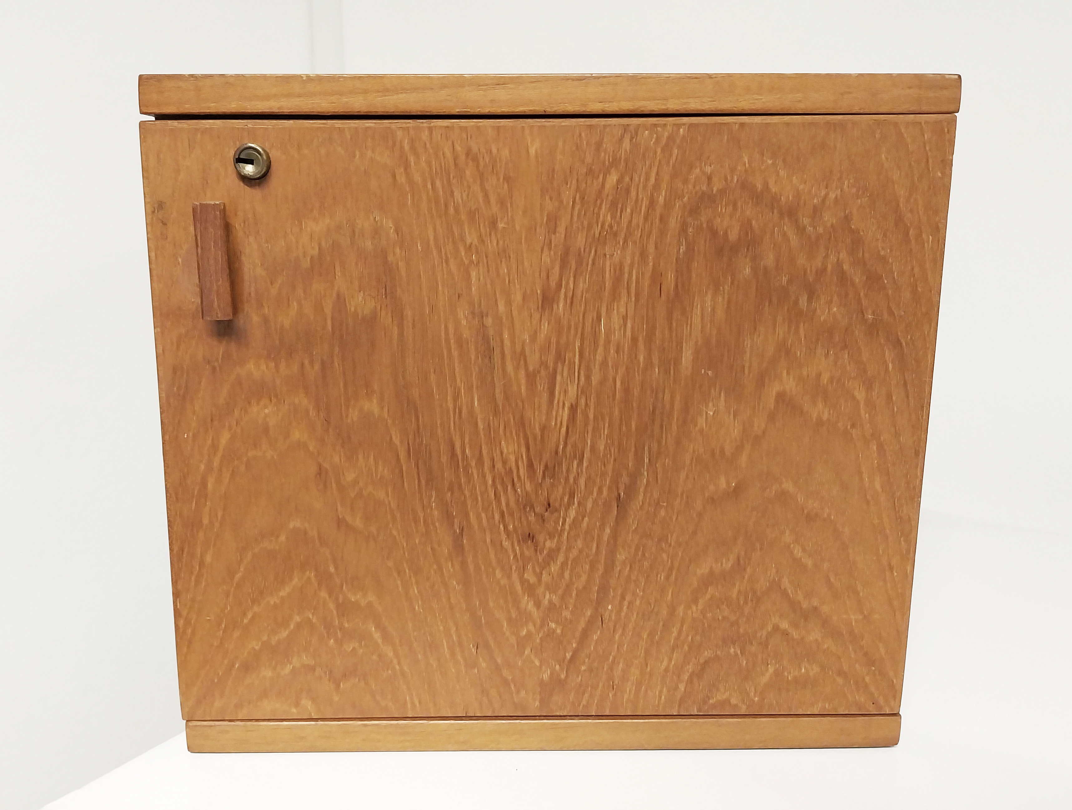 A modern wooden Lembit coin cabinet with single door. . Minor marks and ...