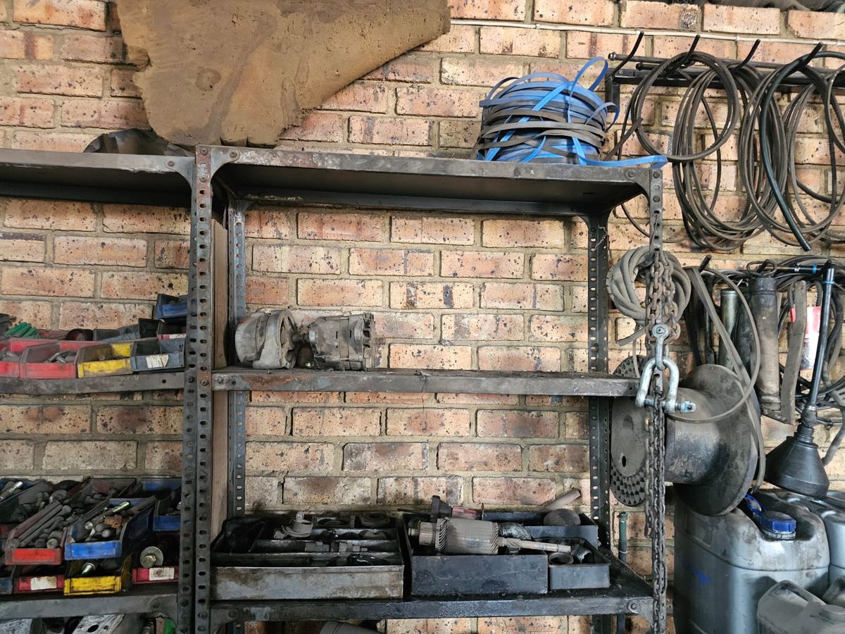 LOT OF TWO (2) STEEL RACKS WITH TABLE & VARIOUS WORKSHOP SPARES | Panabid